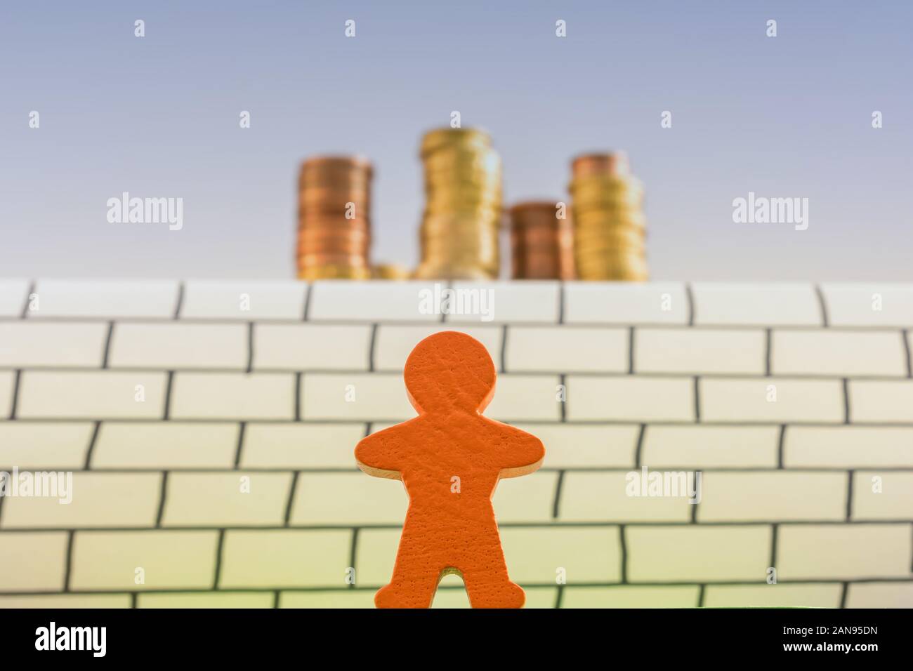 Wooden figures stand in front of an insurmountable wall with a big ...