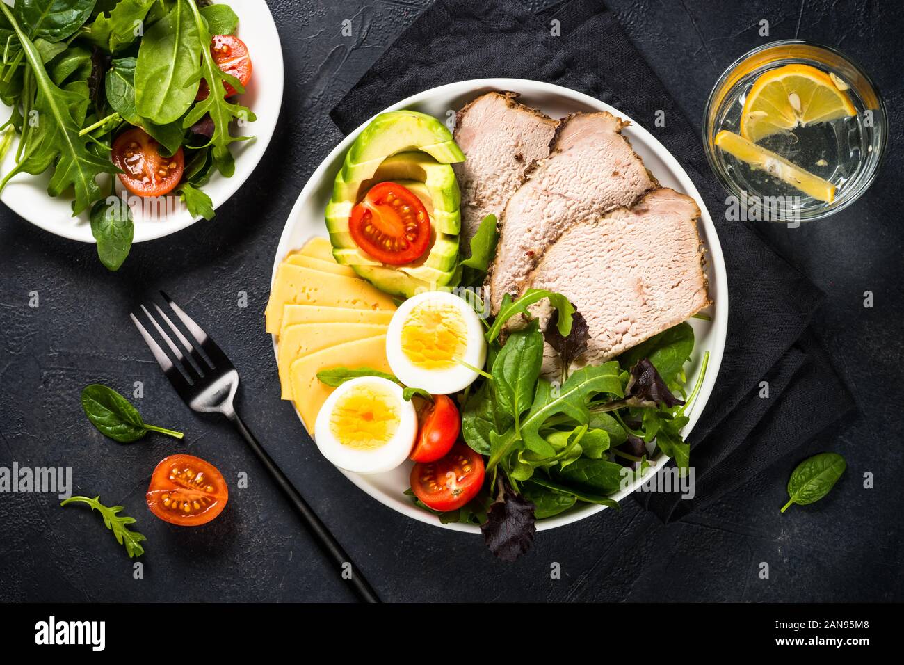 Keto diet plate on black stone table Stock Photo Alamy