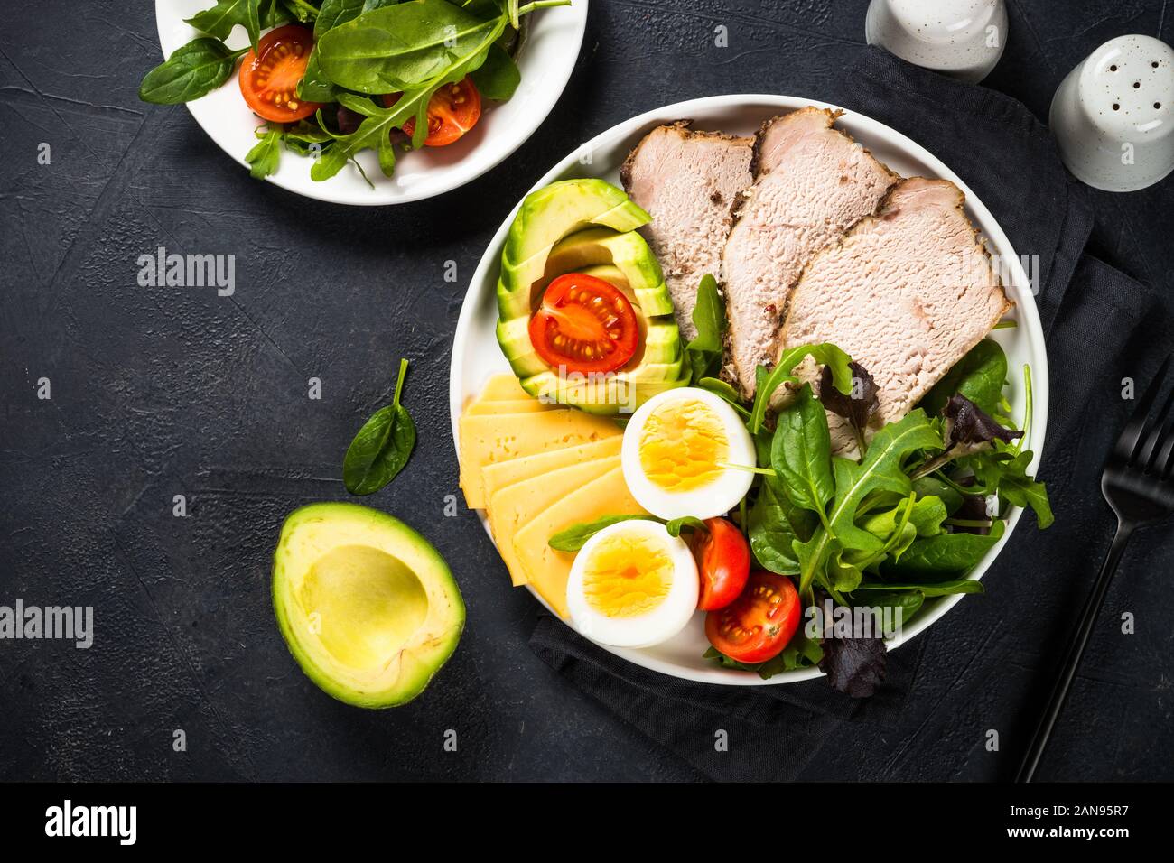 Keto diet plate on black stone table Stock Photo - Alamy