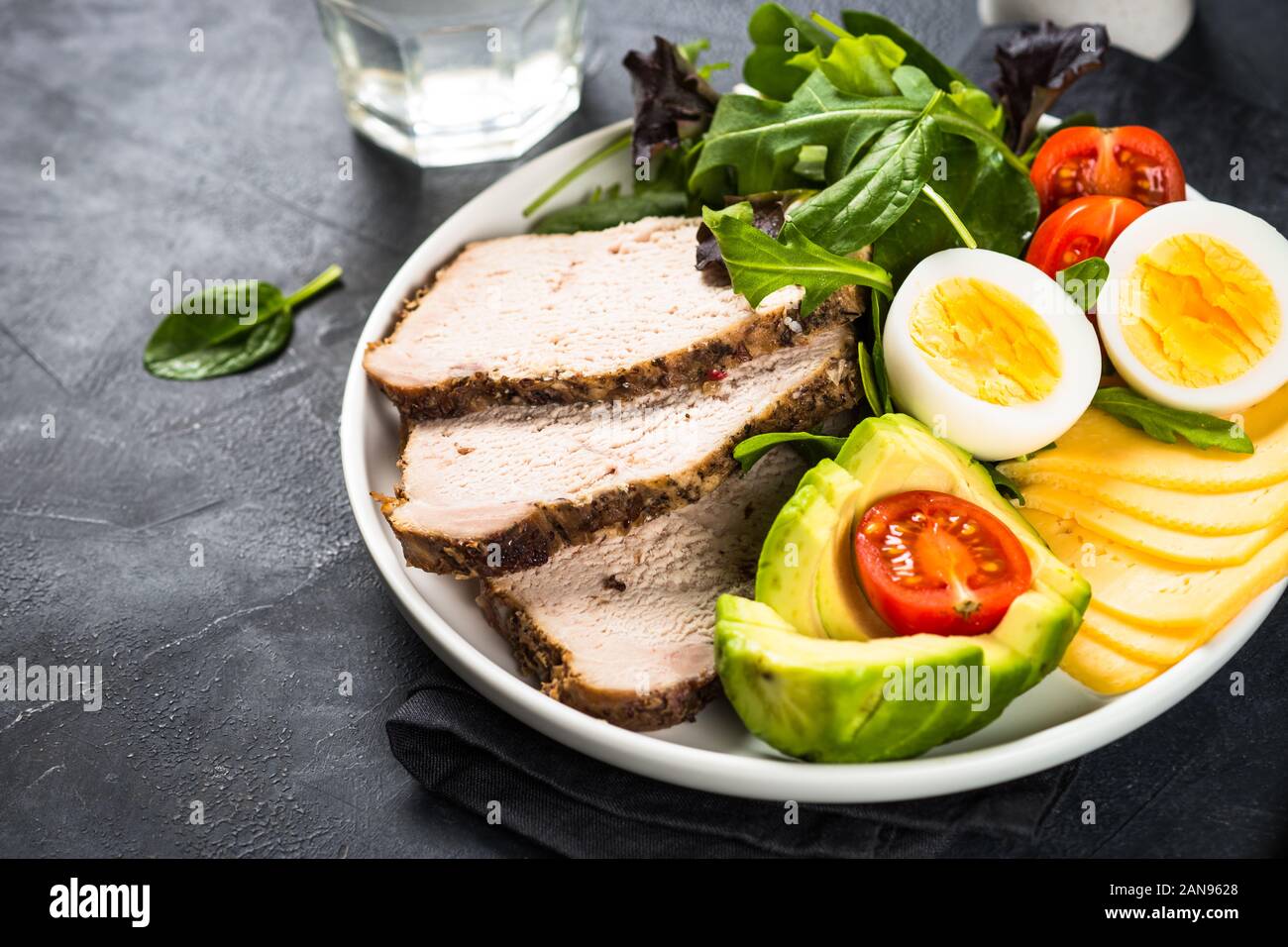 Keto diet plate on black stone table Stock Photo - Alamy