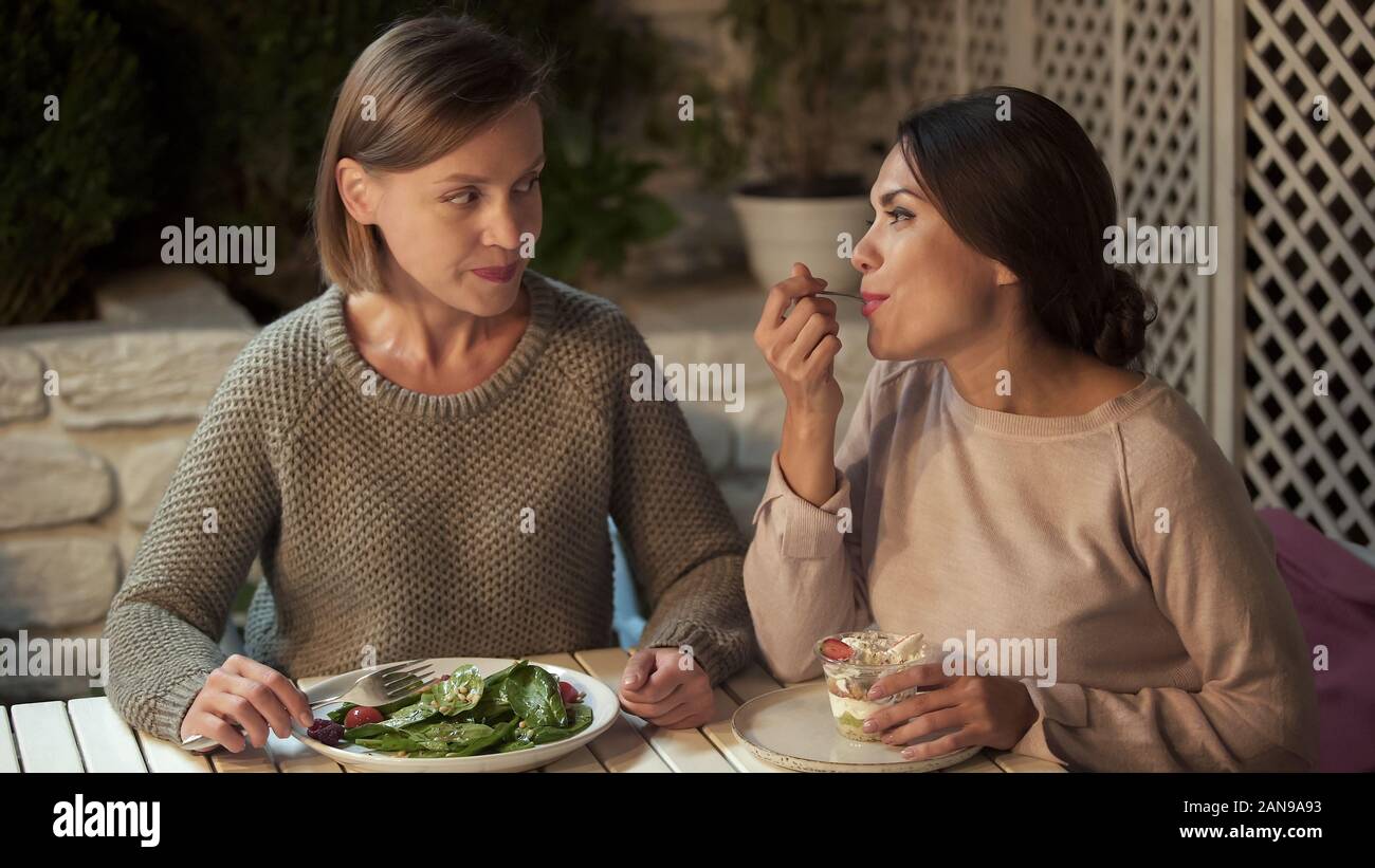 Lady teasing female friend eating hi-res stock photography and images ...