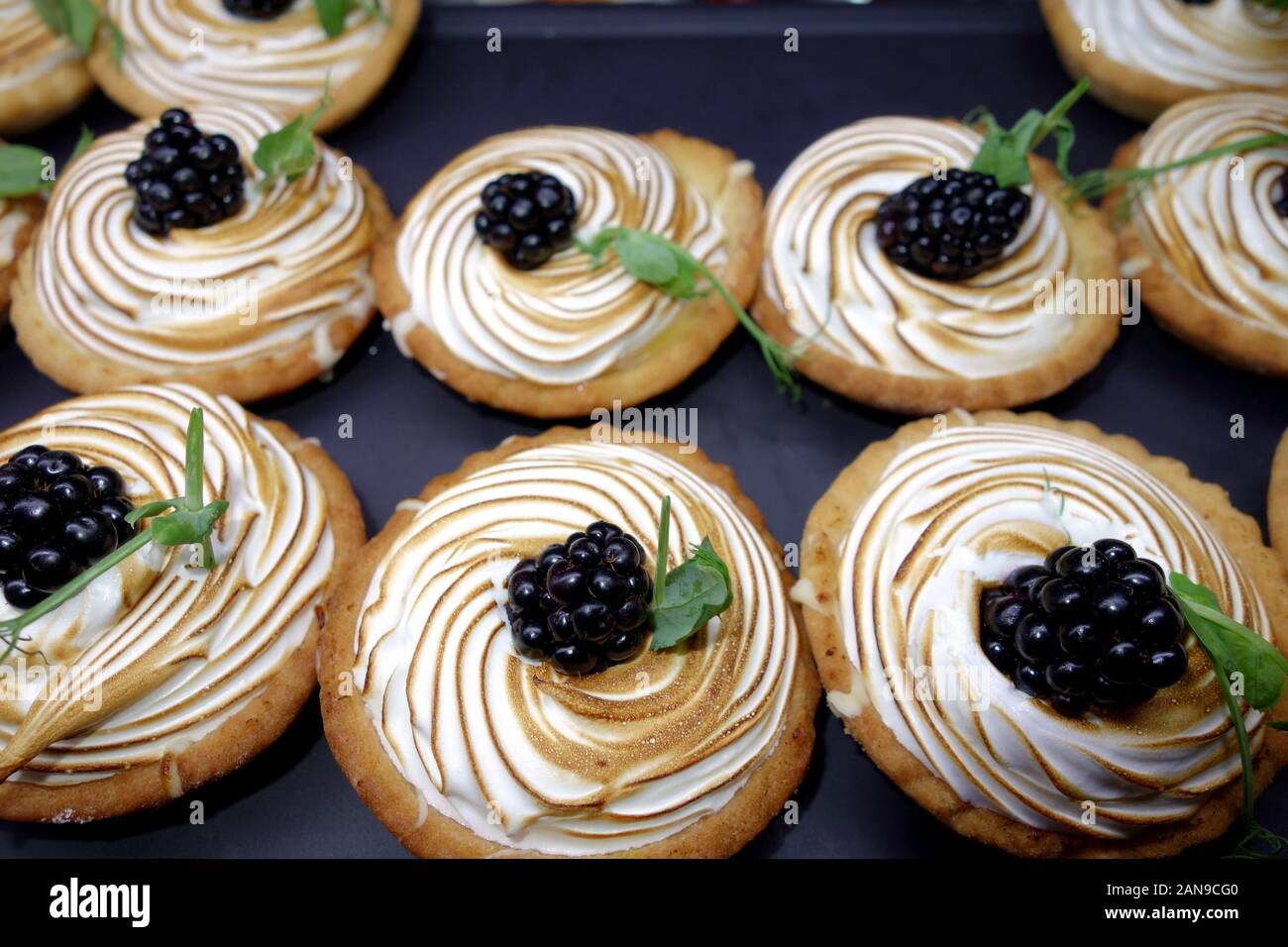 Small Meringue Filled Tarts Topped with Blackberries in the Buffet at ...