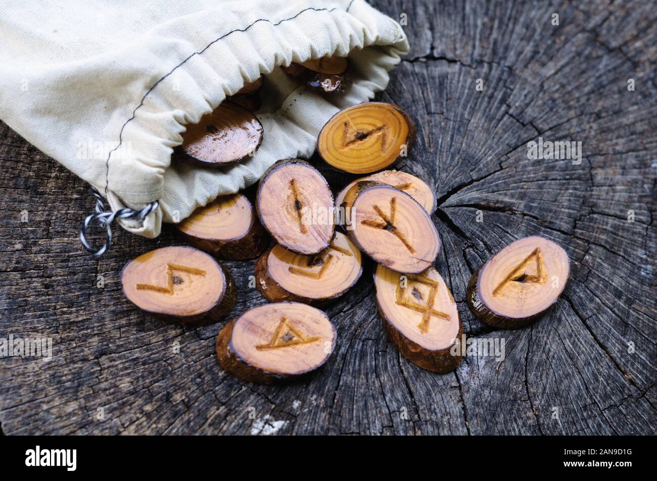 wooden runes in a canvas bag on an old stump Stock Photo - Alamy