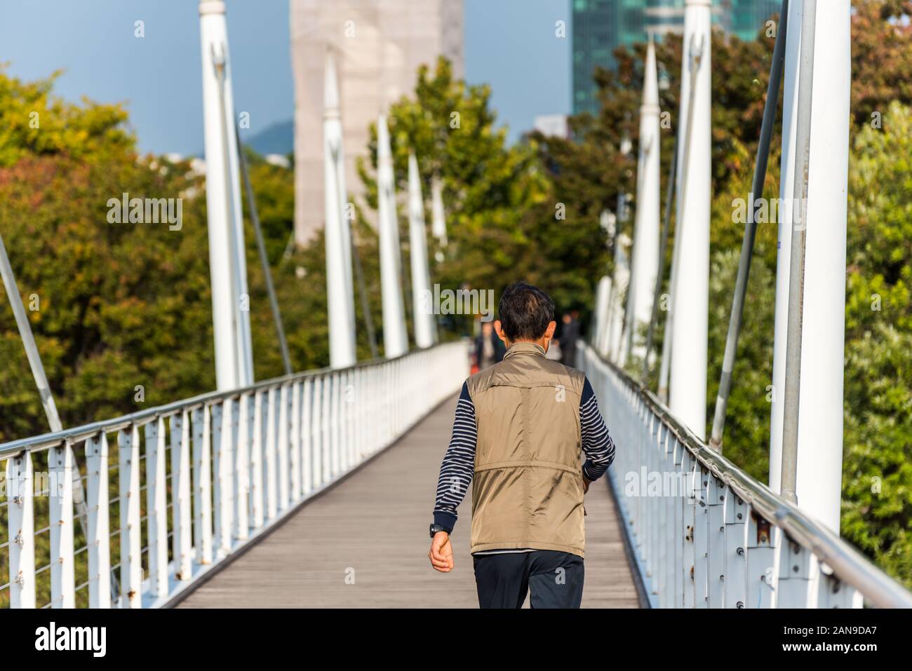 People jogging on the bridge at the Seoul forest park in downtown of ...