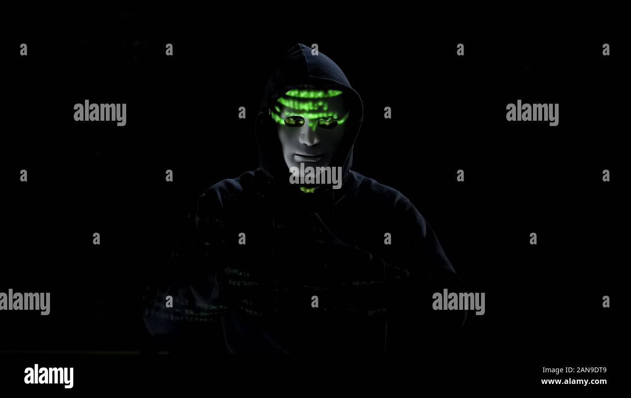 Male criminal in white mask robbing bank, hacking electronic security ...
