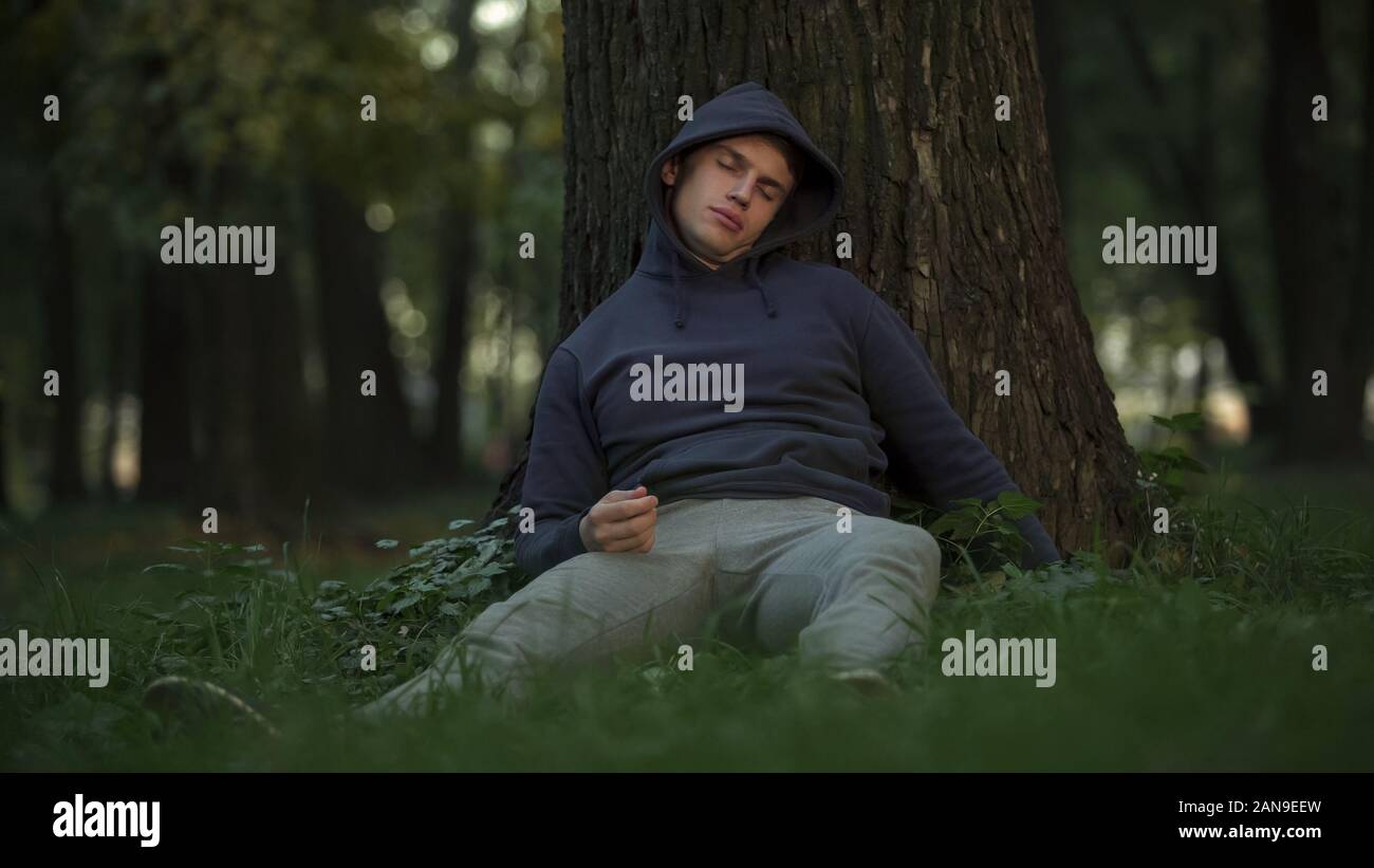 Sleeping under tree hi-res stock photography and images - Alamy
