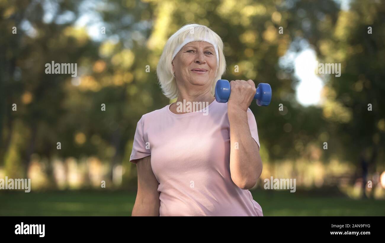 Old lady lifting weights hi-res stock photography and images - Alamy