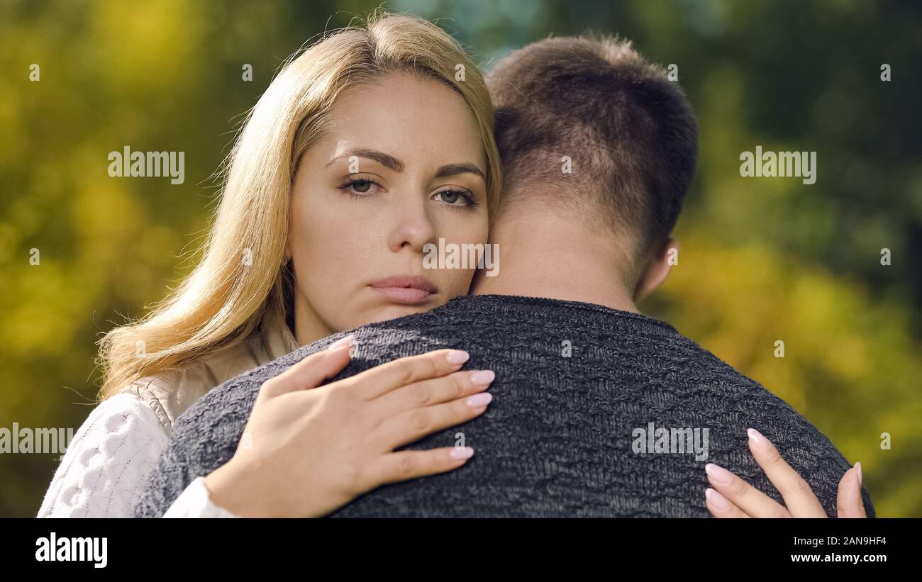 Upset couple hugging, looking wistful, fatal disease diagnosis, support ...