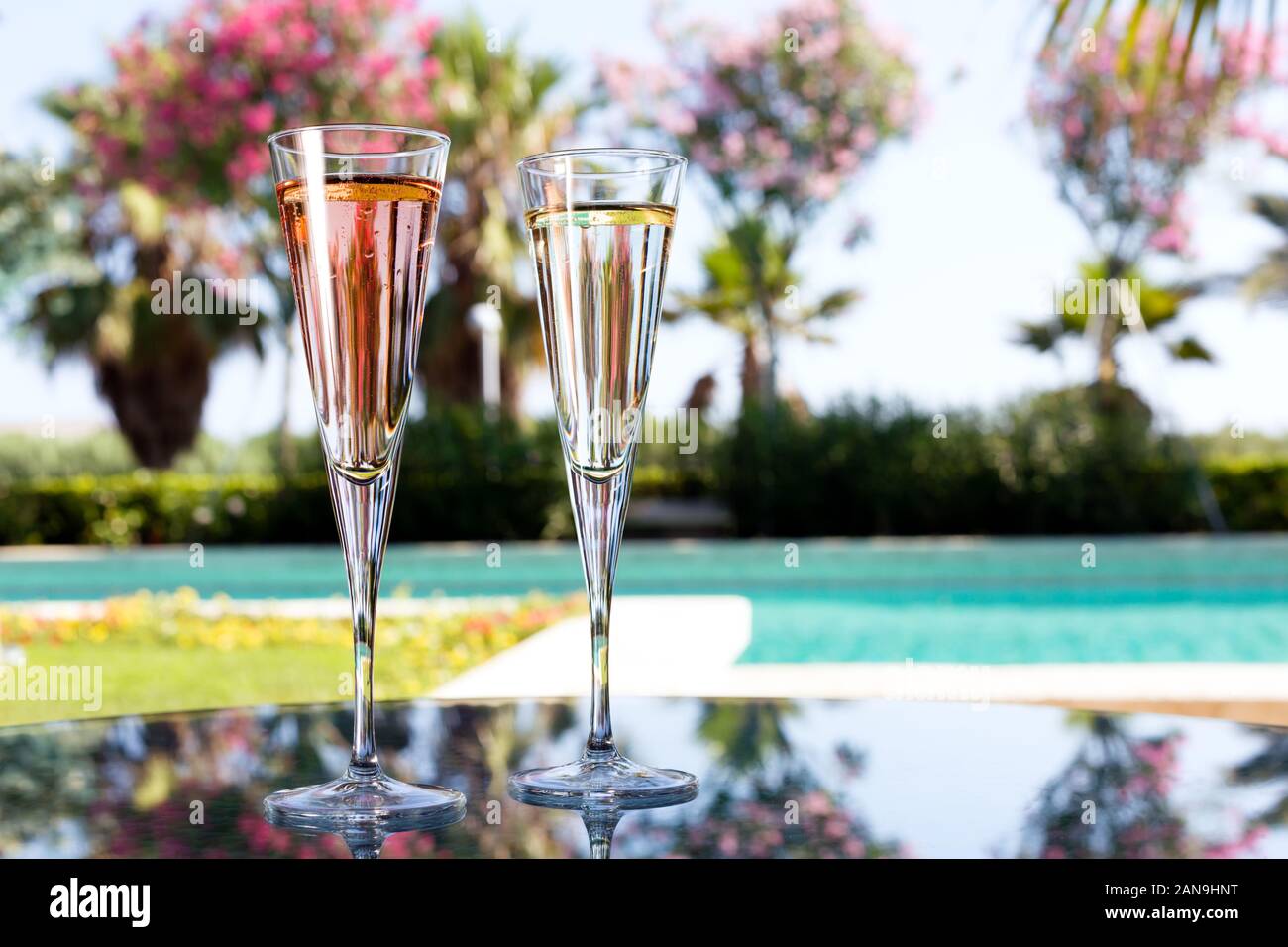 Glass of champagne on the glass table in outdoor resort bar Stock Photo ...