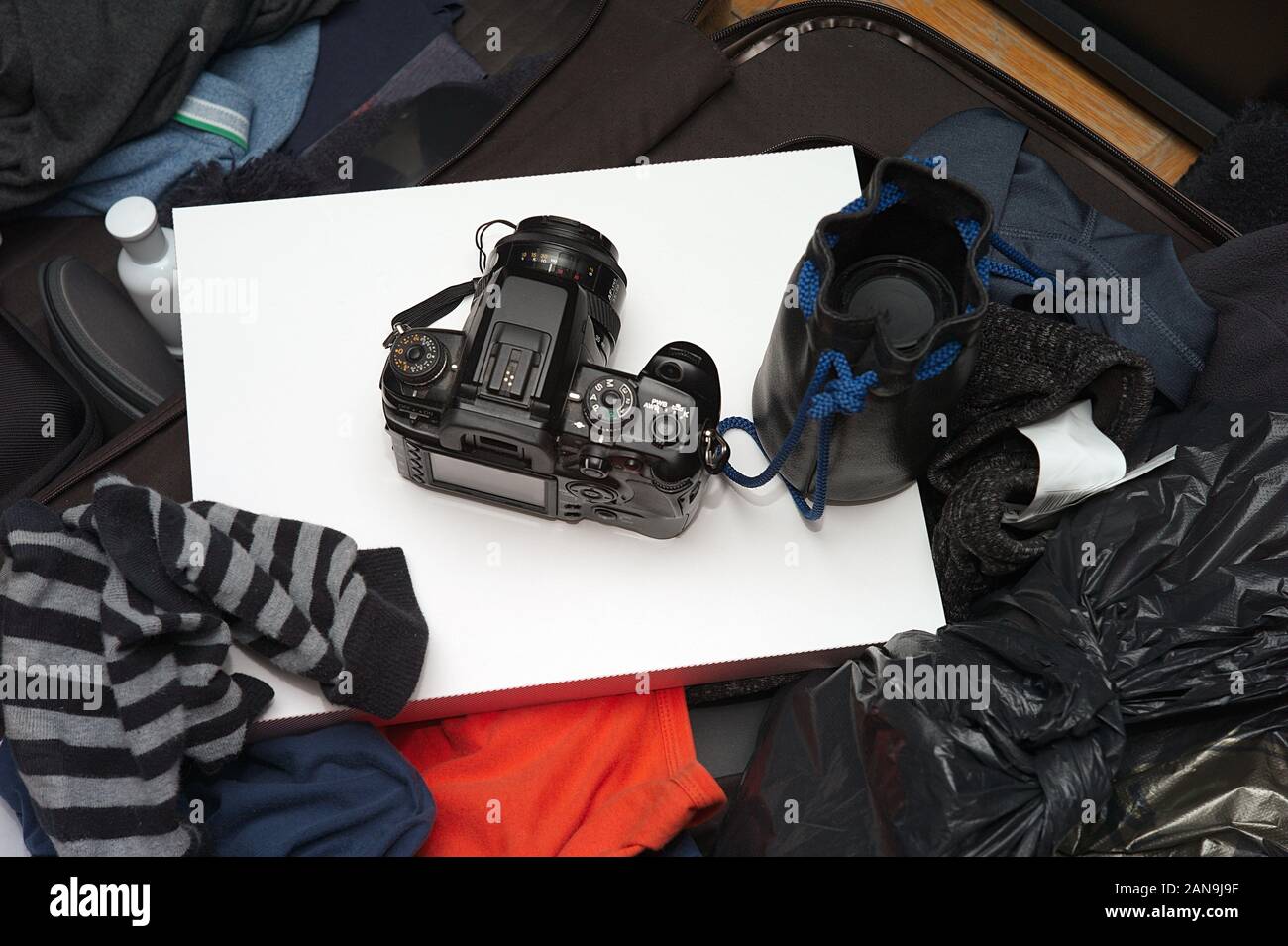A photo camera in the suitcase, full of personal effects in mess Stock ...