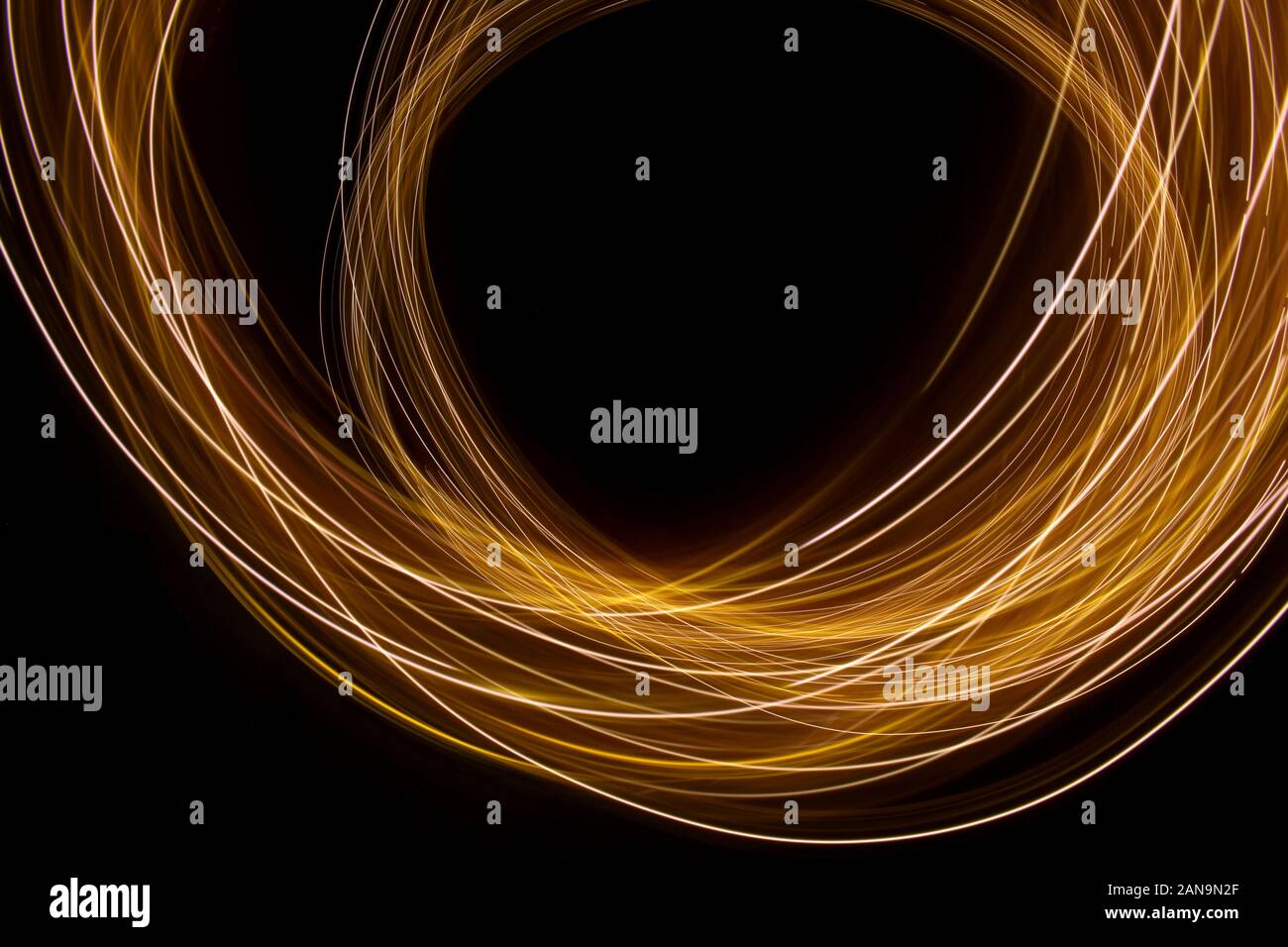 Long exposure light painting, vibrant color in abstract swirls against ...