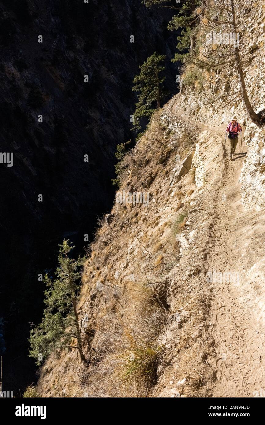 Female trekker on a precipitous trail on the Lower Dolpo trek in the ...