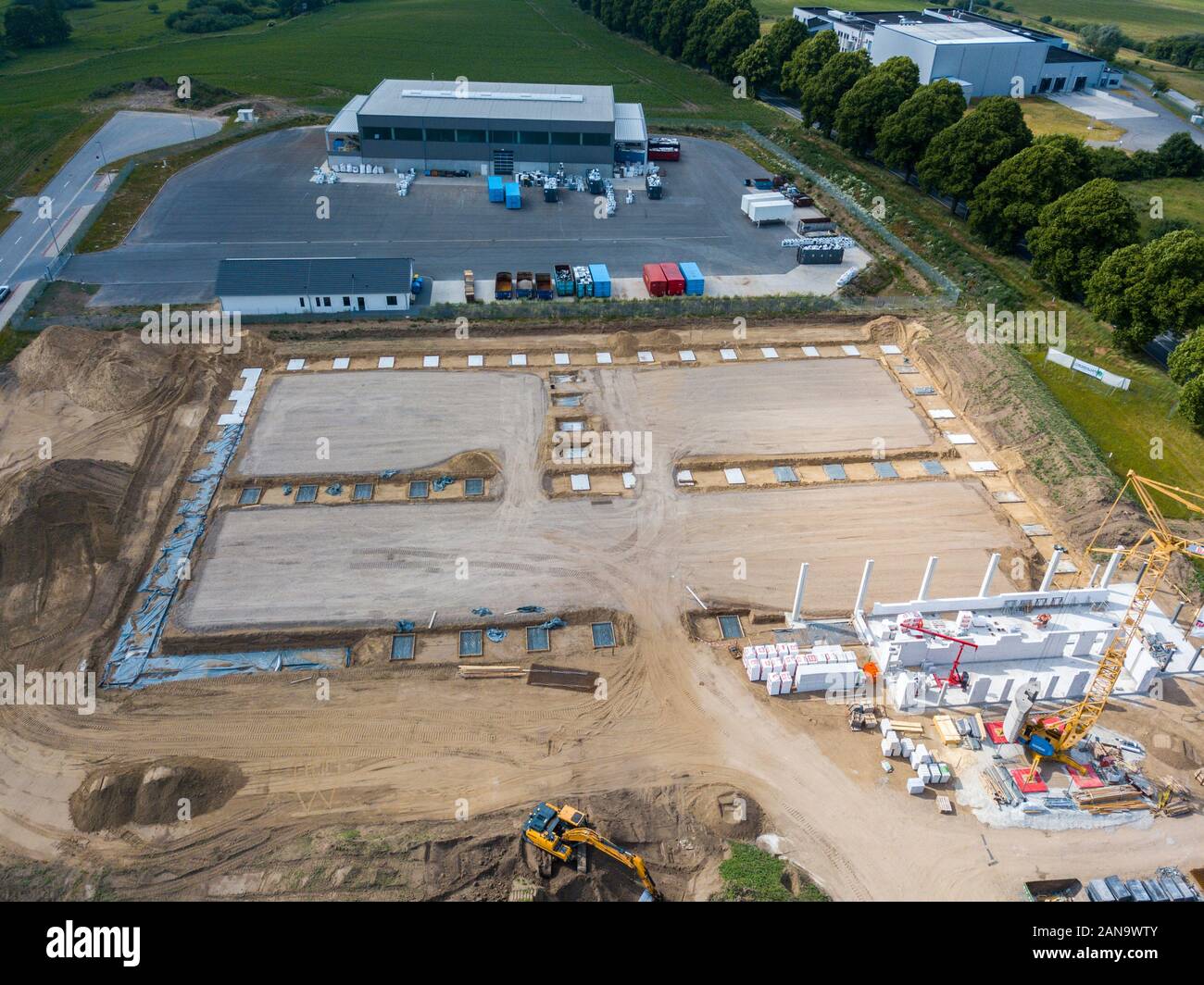 Drone photos of a large construction site on which a factory building ...