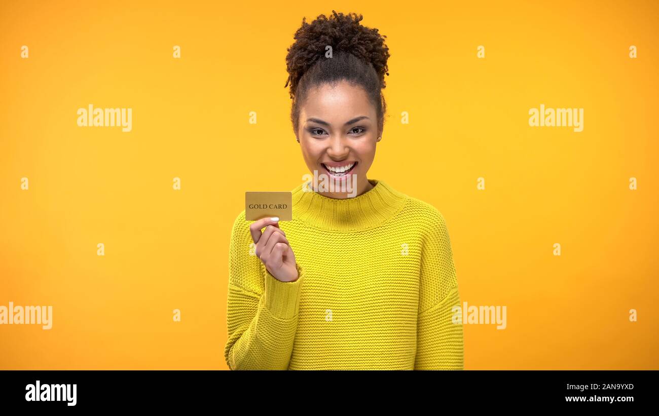 Black woman holding golden credit card, VIP banking programs for rich ...