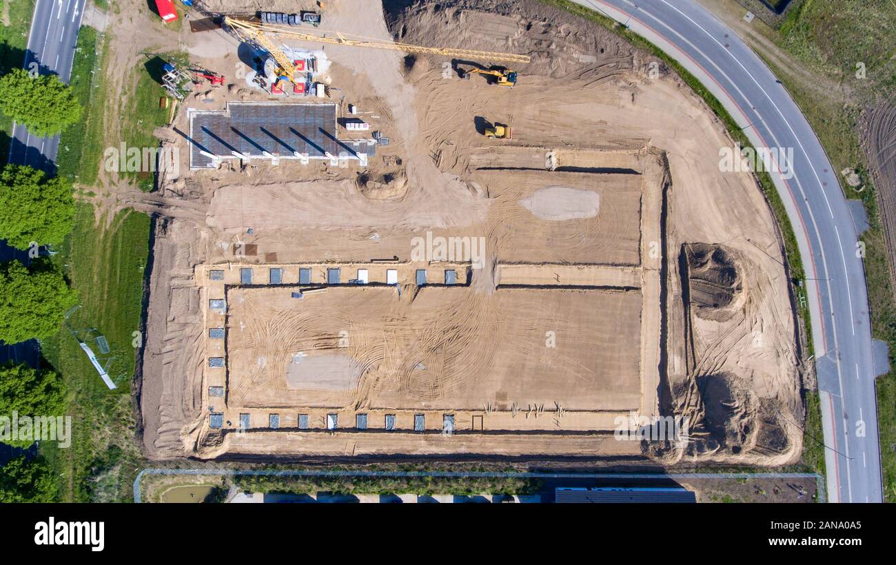 Drone photos of a large construction site on which a factory building ...