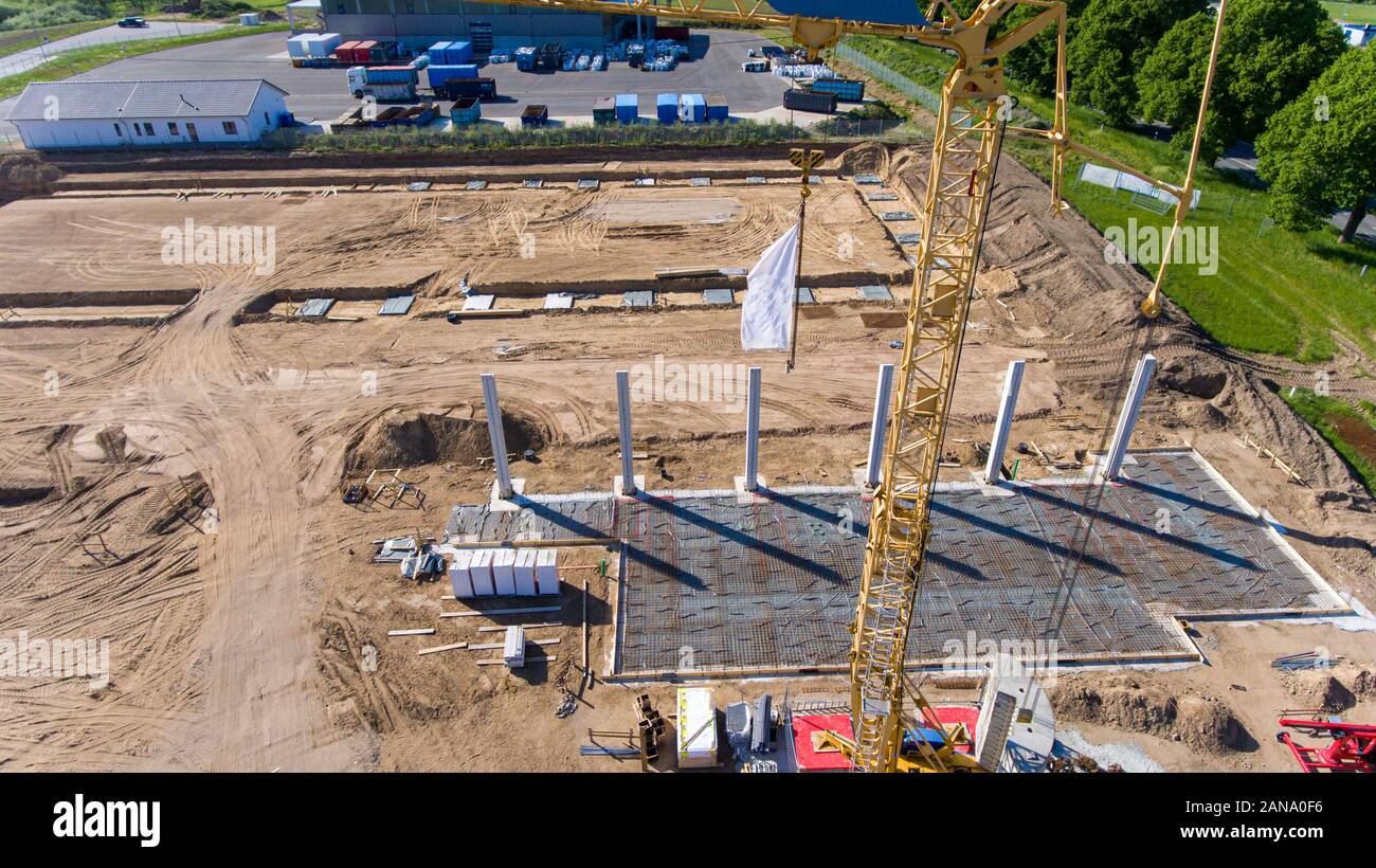 Drone photos of a large construction site on which a factory building ...