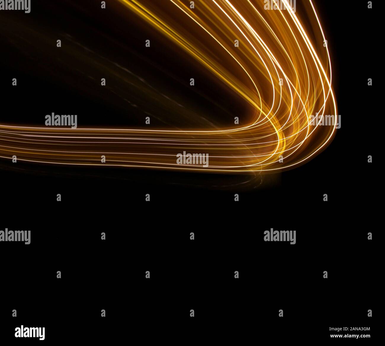 Long exposure light painting, vibrant neon gold color in abstract ...