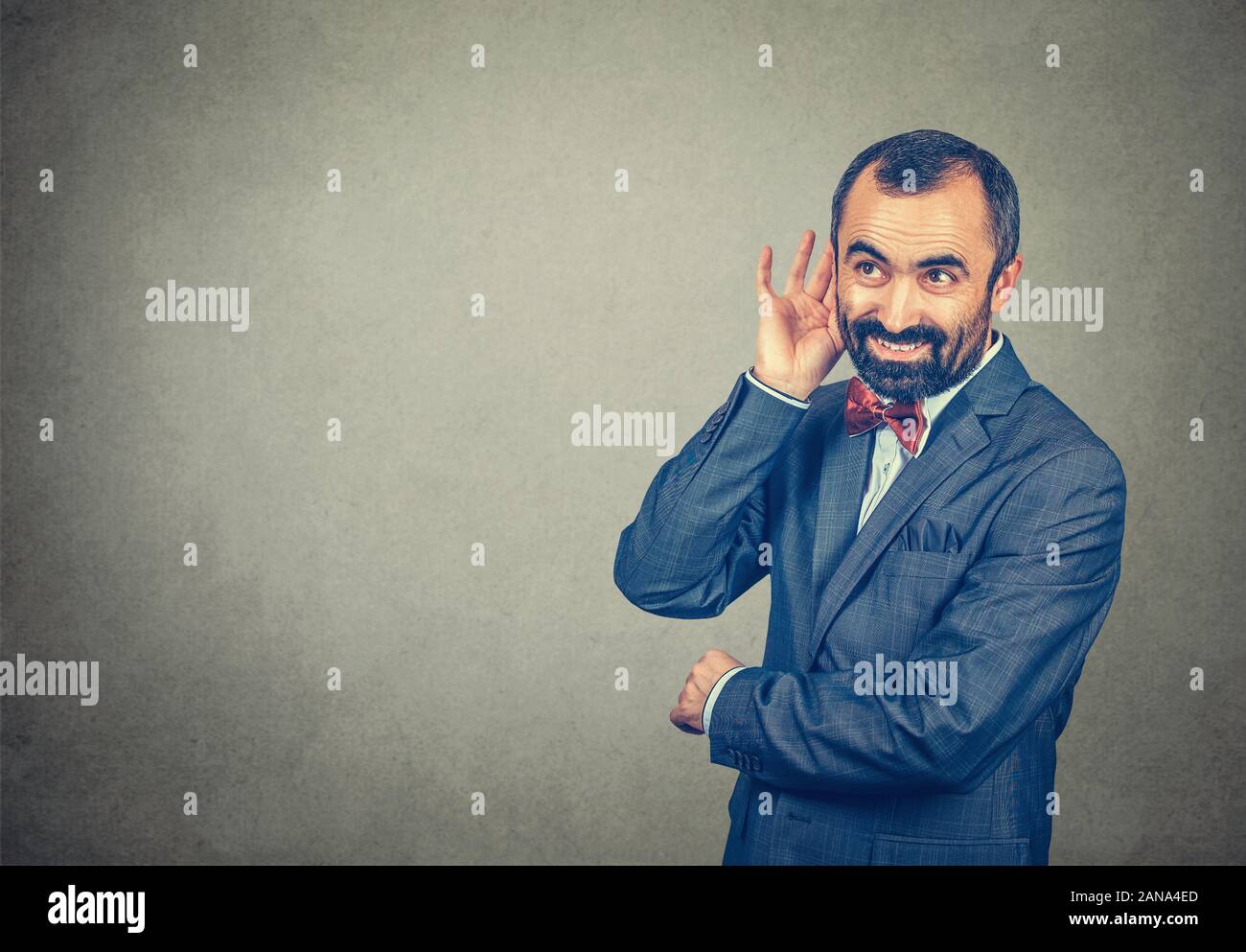man eavesdropping smiling happy, businessman with his hand to his ear ...