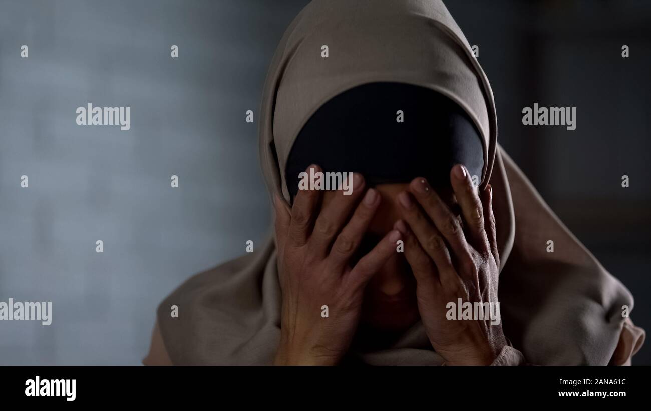 Desperate muslim woman crying, covering face with hands, family problem ...