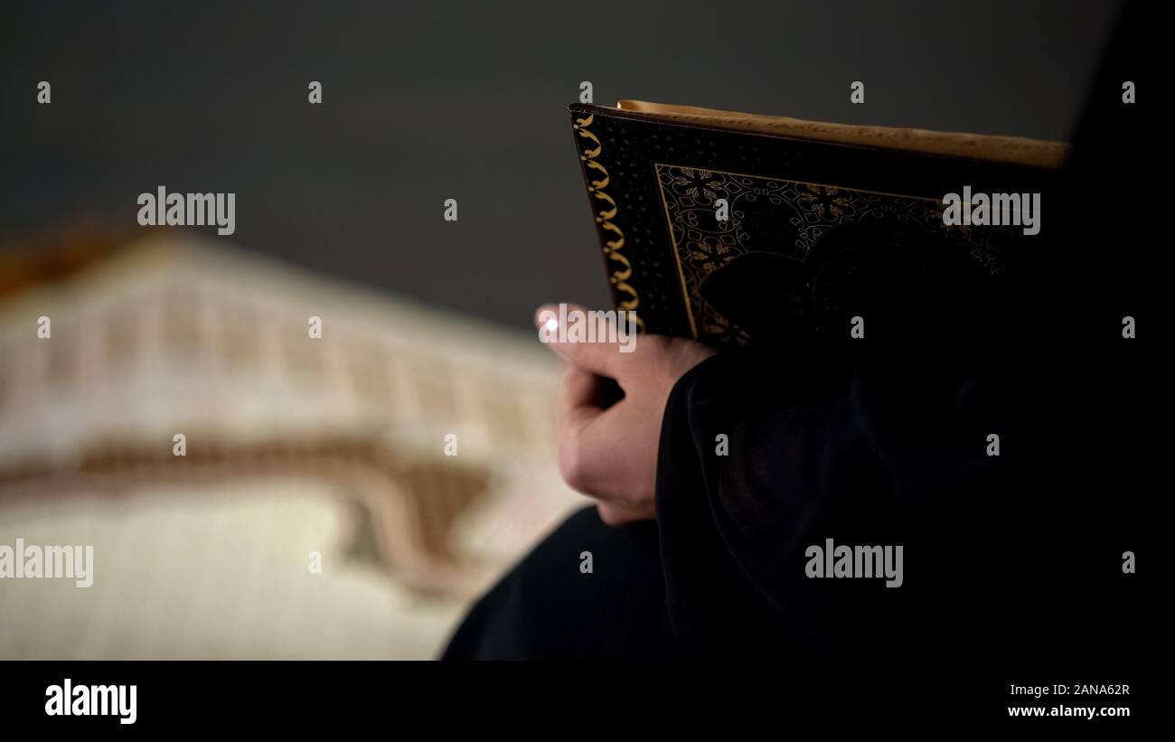 Muslim woman reading quran, sitting on ground in mosque, holy guidance ...