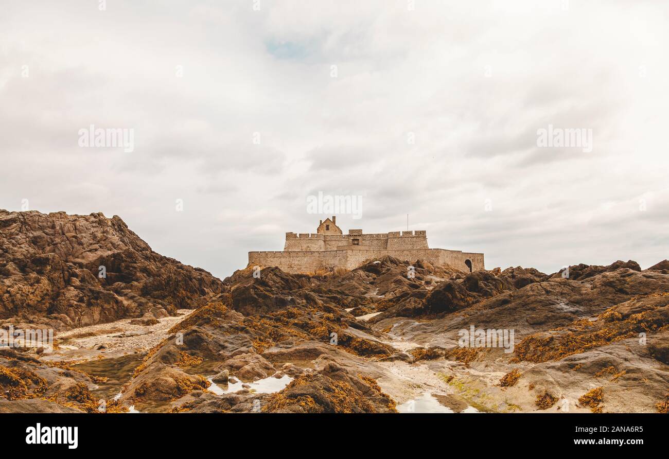 landscape of a medieval fortress on the French coast seen at low tide ...