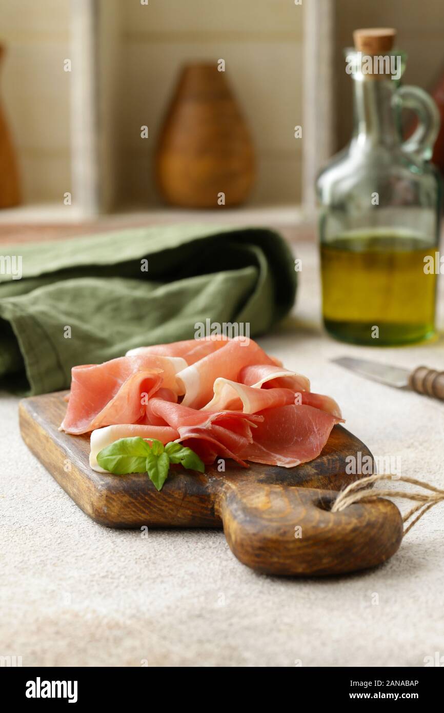 traditional smoked prosciutto ham on a wooden board Stock Photo - Alamy