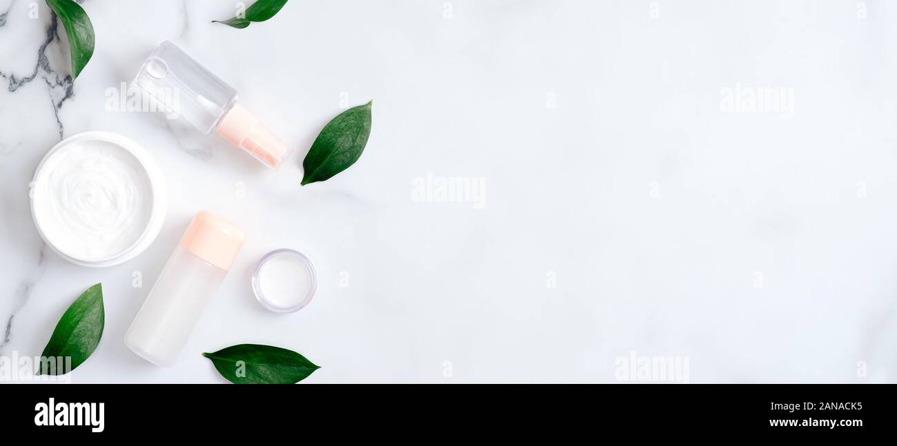 Natural organic cosmetic lotion bottles and hand cream on marble ...