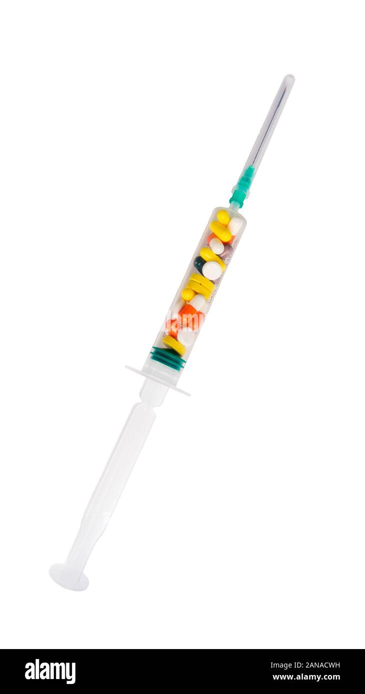 syringe filled with dose of medication pills and colored capsules ...