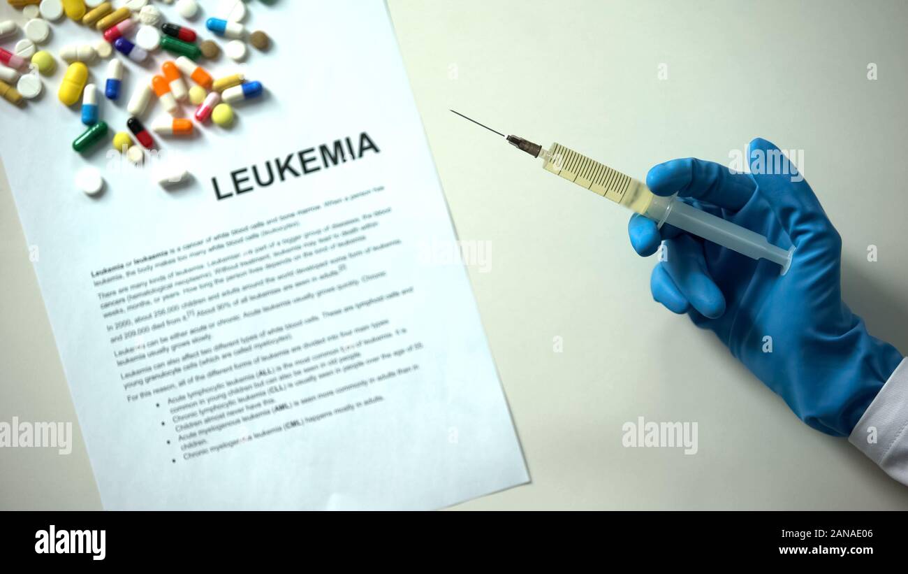 Leukemia diagnosis on paper, doc hand with syringe, pills and tablets ...
