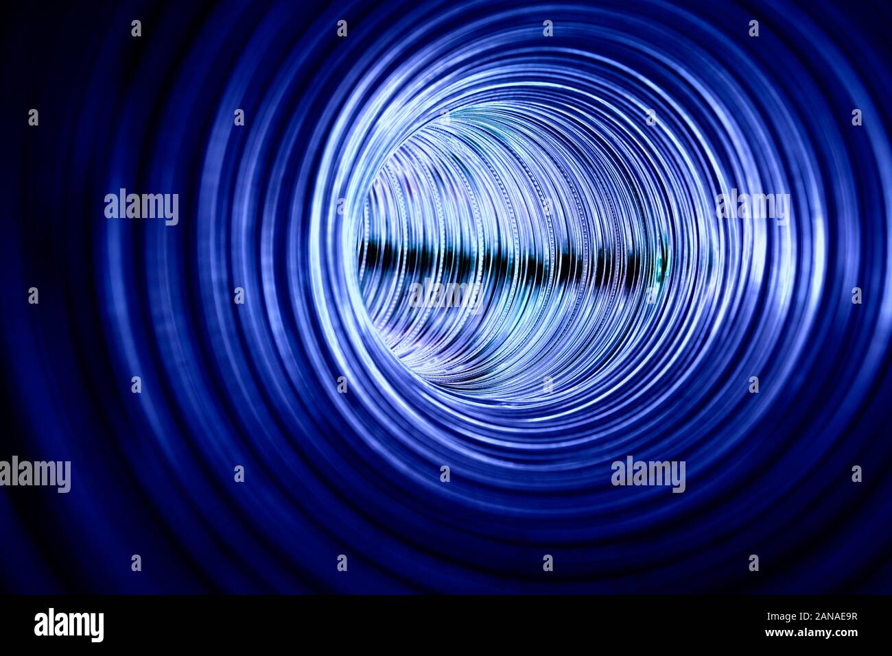 Science fiction like metallic circular tunnel illuminated by blue light ...