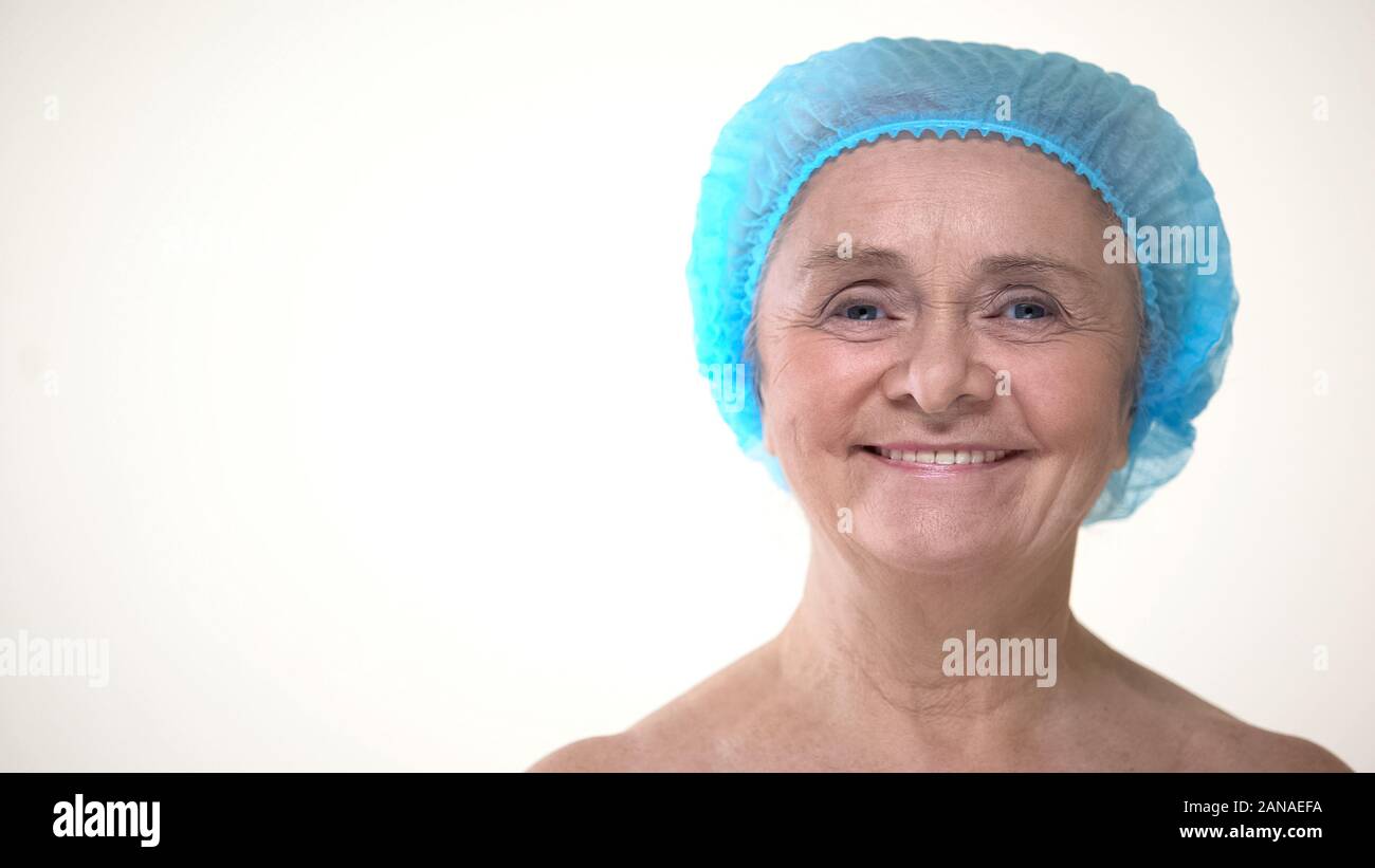 Portrait of old woman in hygienic cap before plastic surgery ...