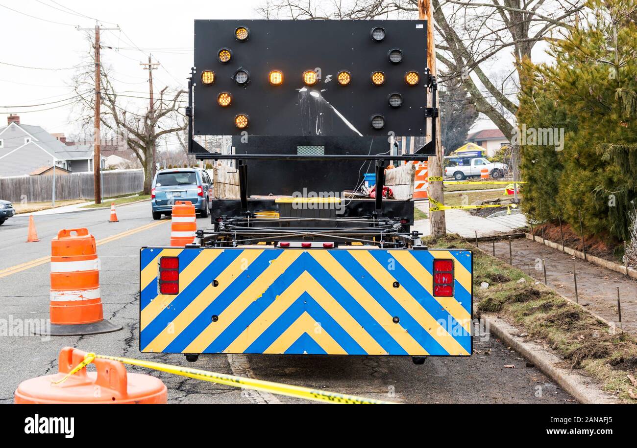 A construction truck has an arrow telling cars to stay to their left ...