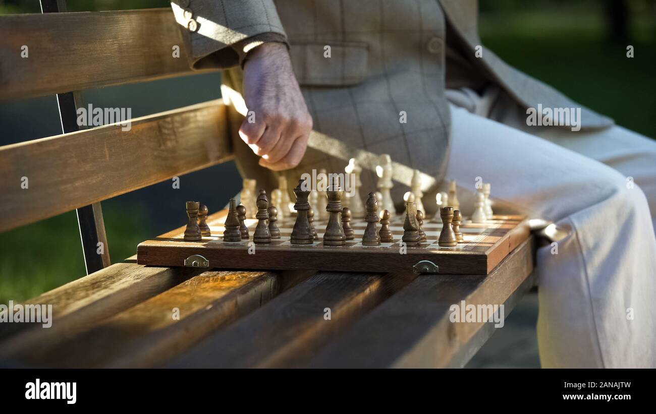 Old man resting and playing chess alone in park, retirement benefits ...