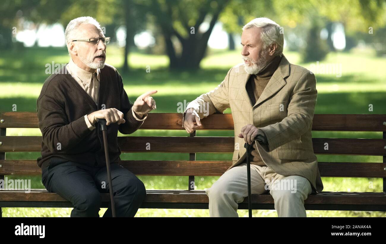 Two old men talking in park hi-res stock photography and images - Alamy