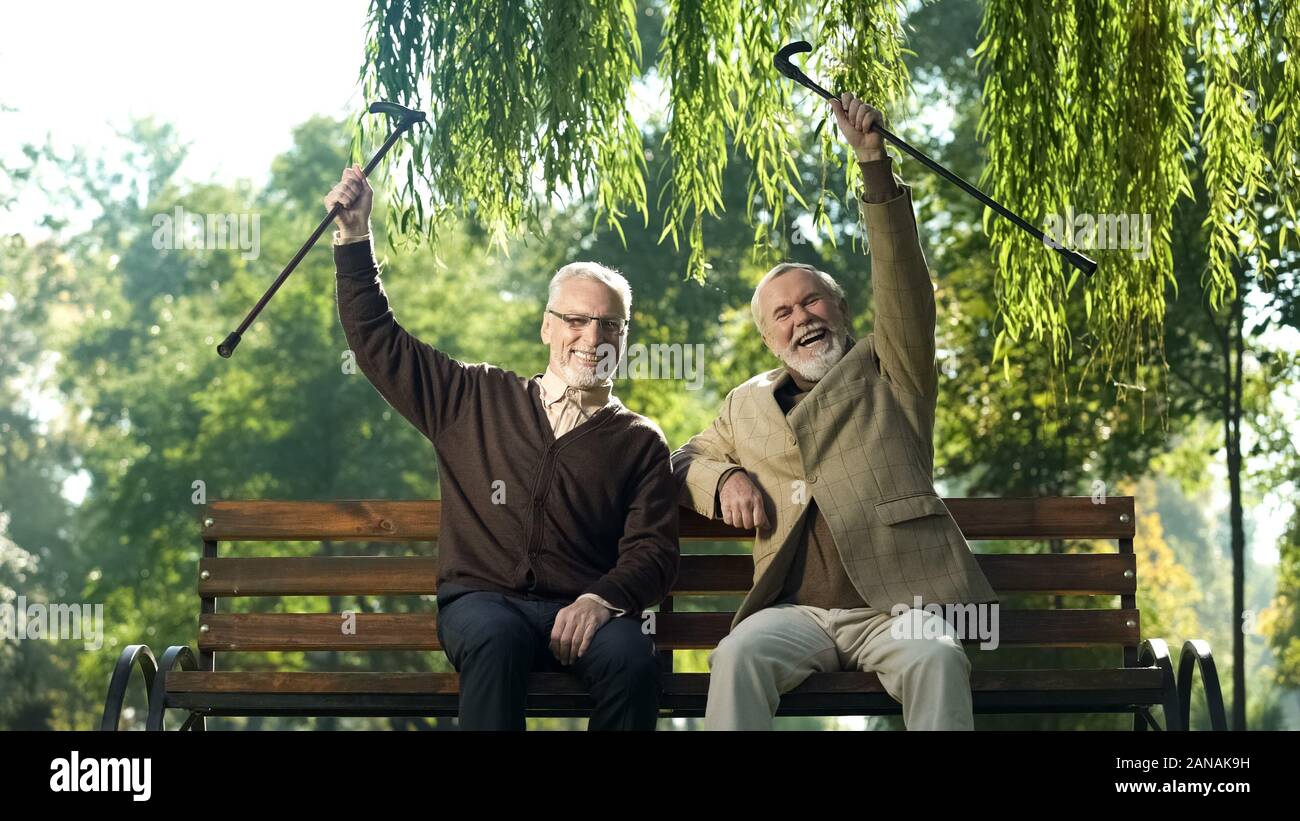 Two elderly people walking canes hi-res stock photography and images ...