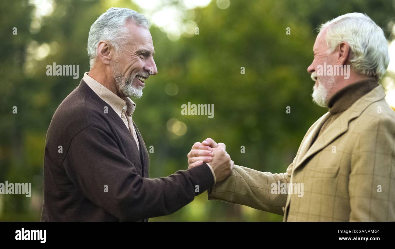 Two old friends hugging each other hi-res stock photography and images ...