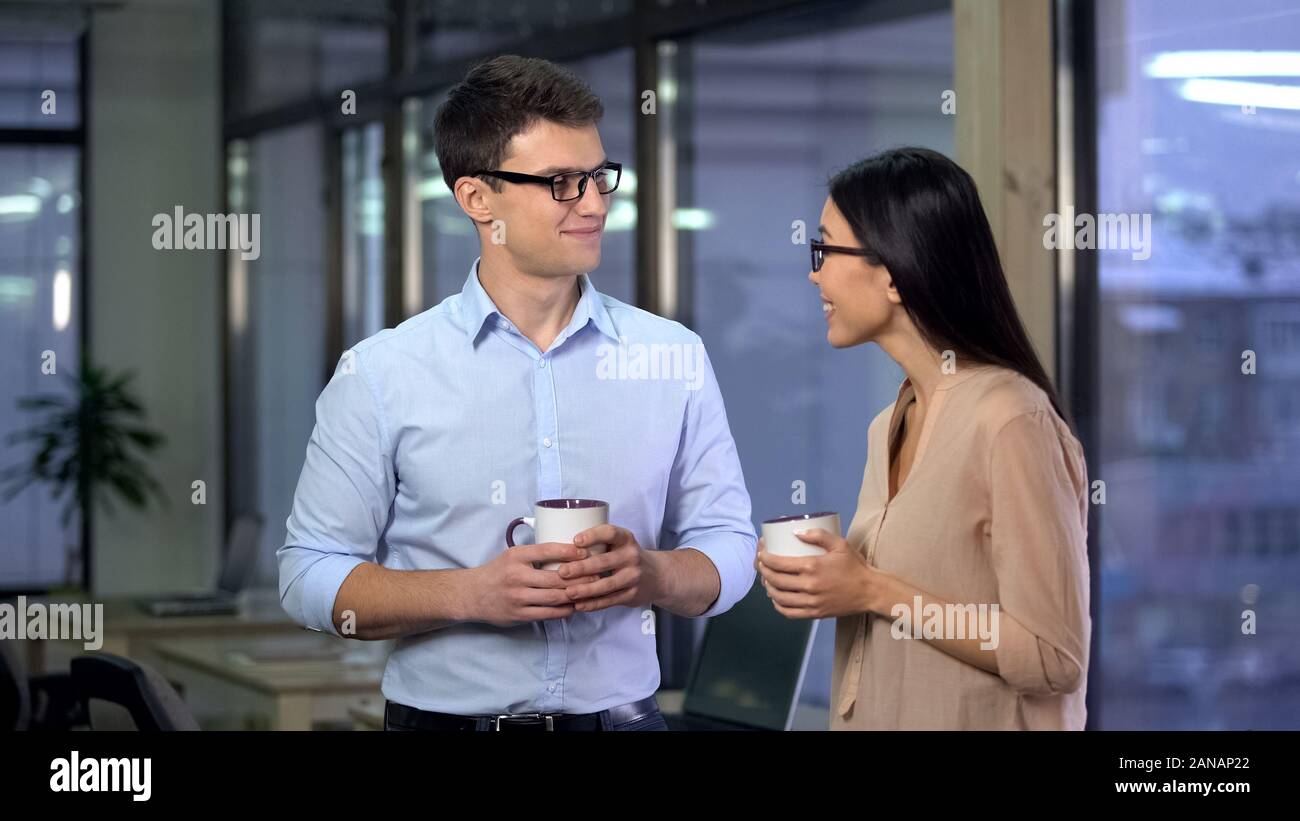 Couple teammates chatting during hi-res stock photography and images ...