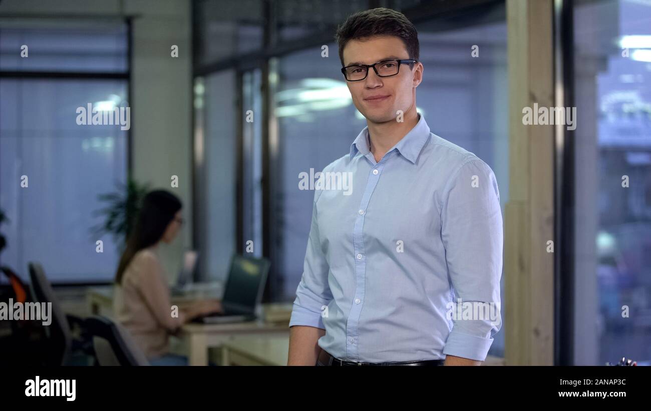 Handsome man posing on office background, official employment, business ...