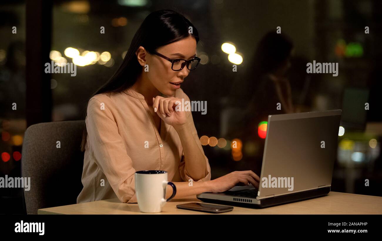Female journalist typing article, cup of coffee on table, work ...