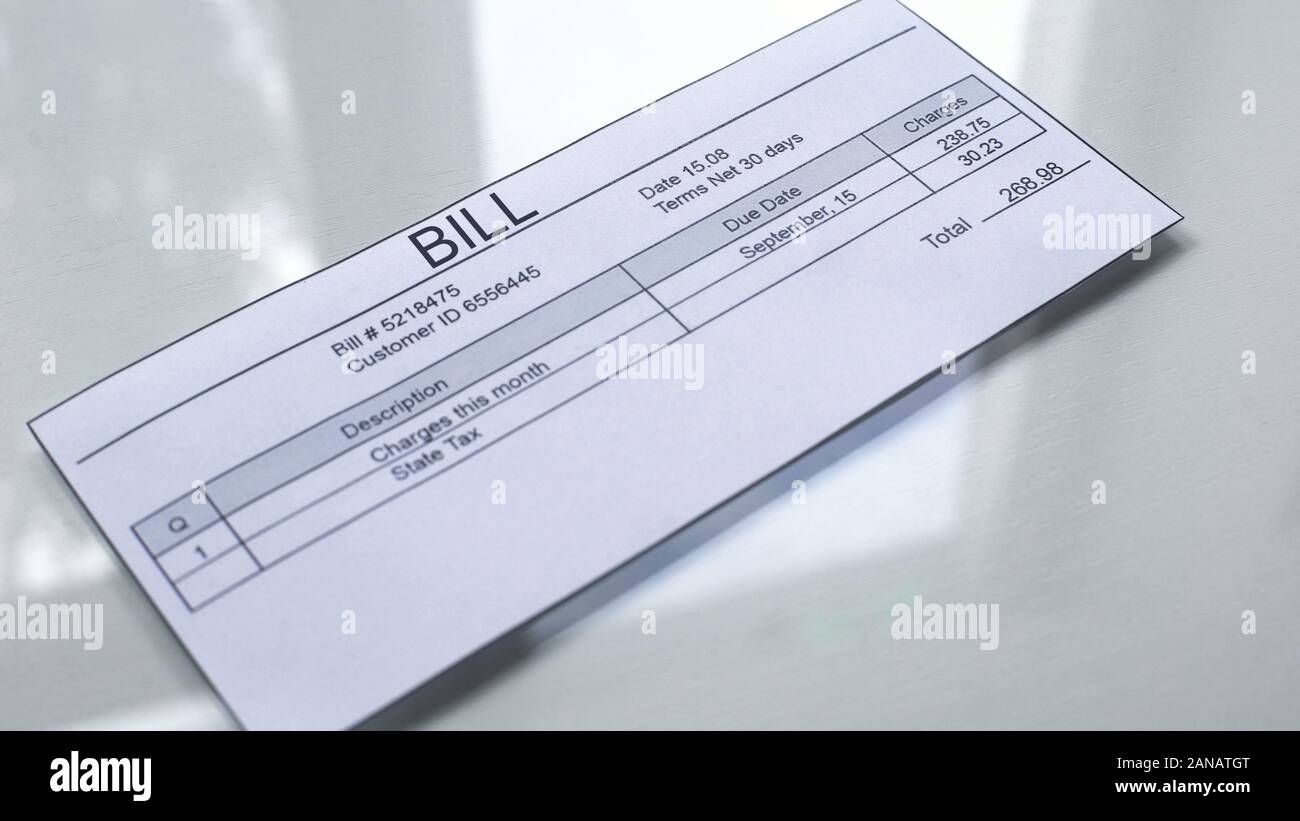 Bill lying on white table, payment for services, month expenses ...