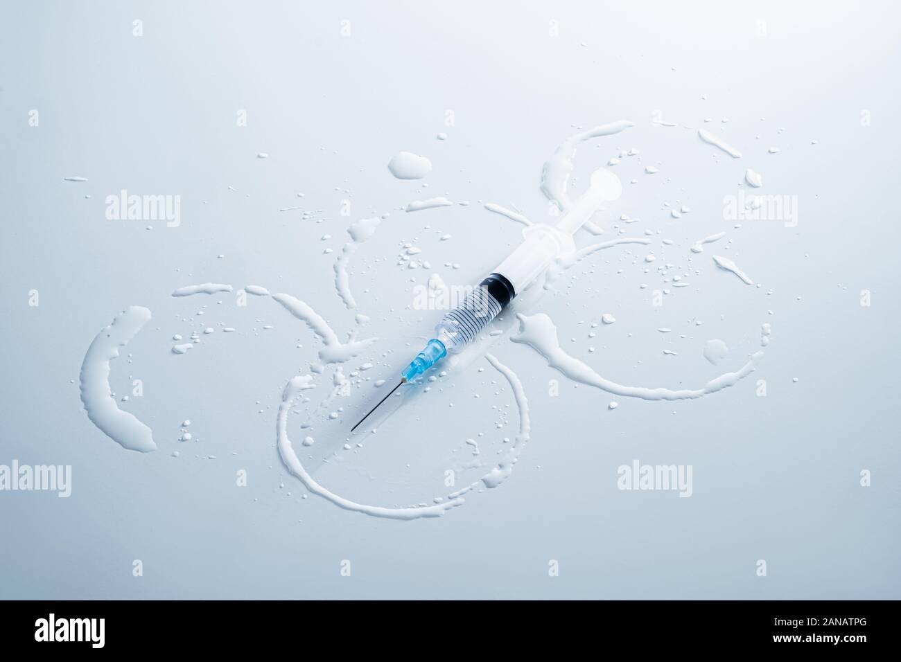 Water circles shaping the symbolf of the olympic games and a syringe ...