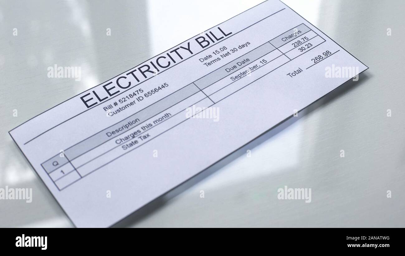 Electricity bill lying on table, payment for services, month expenses ...