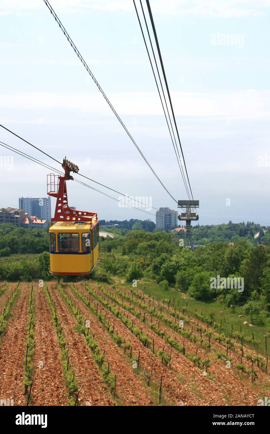 Cableway over green gardens. Cable car cabin above the field Stock ...