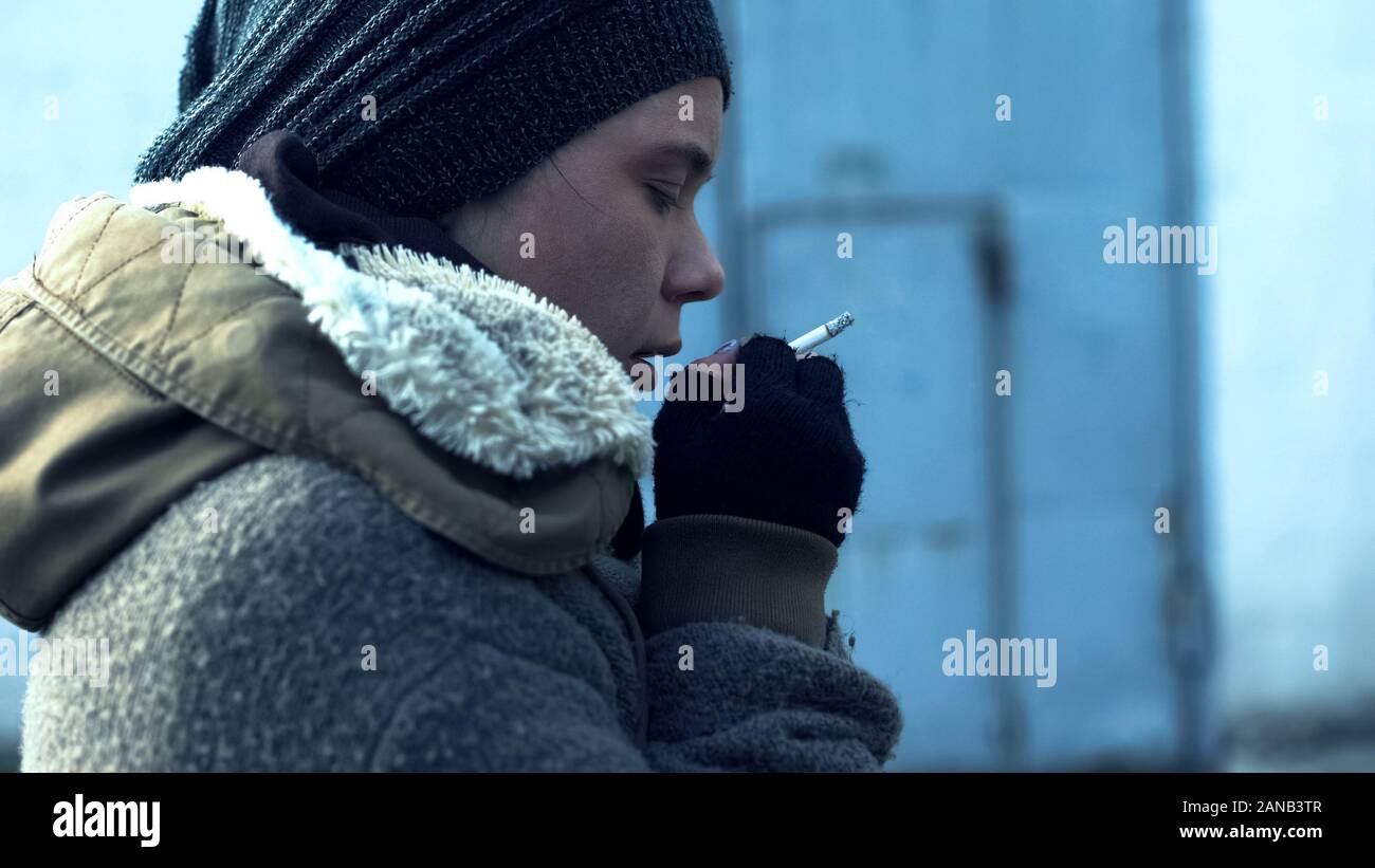 Addicted homeless woman smoking cigarette feeling cold, social problem ...
