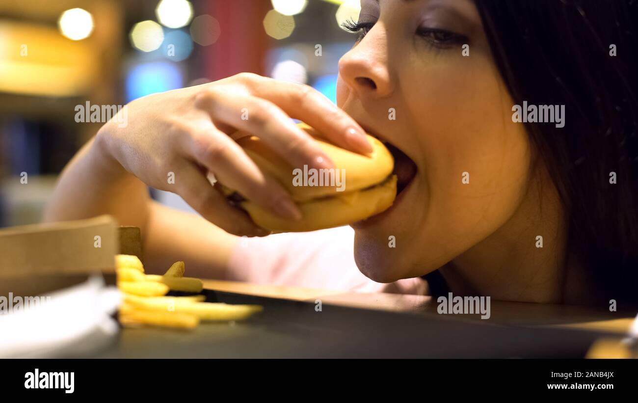 Woman overeating table hi-res stock photography and images - Alamy