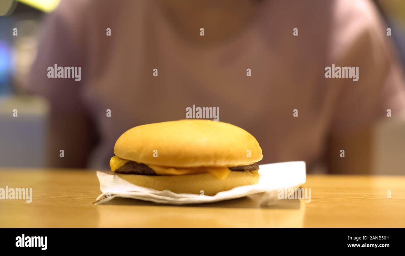 Cheeseburger on table closeup, unhealthy meal, fast food restaurant ...