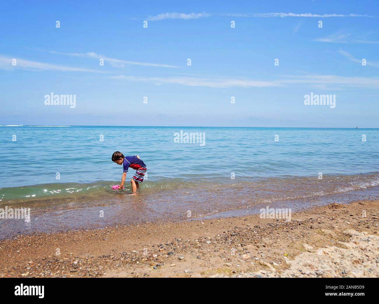 Little boy playing on beach in Summer Stock Photo - Alamy