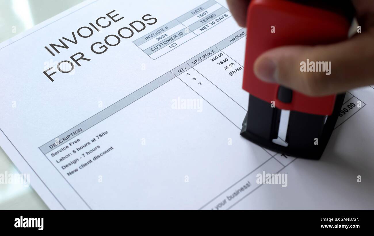 Hand stamping rectangular seal on invoice for goods commercial document ...