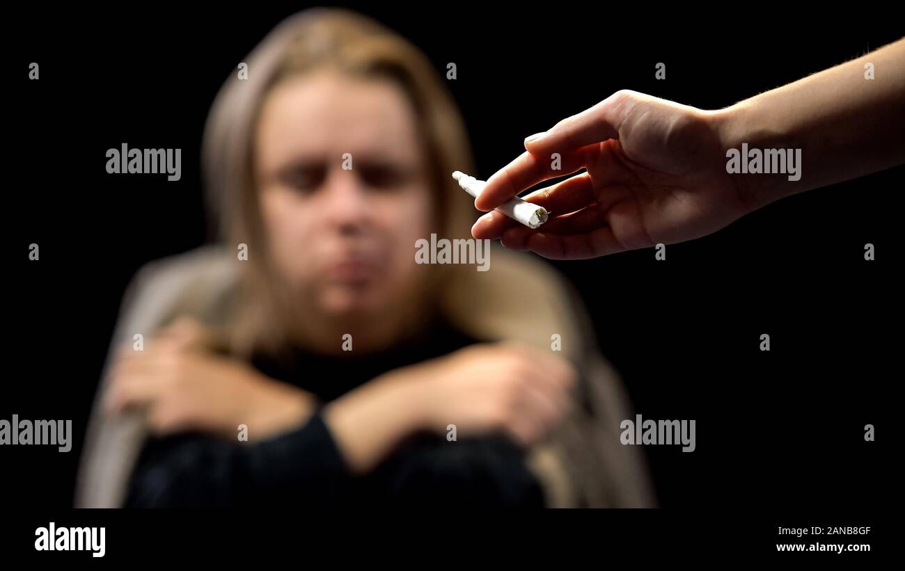 Hand offering weed to depressed homeless woman, drug addiction ...