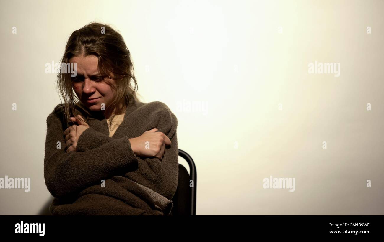 Depressed abuse victim sitting chair on white background, domestic ...